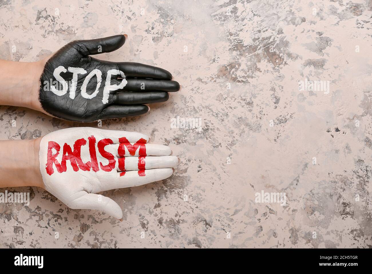 Words STOP and RACISM written on painted female palms against light ...