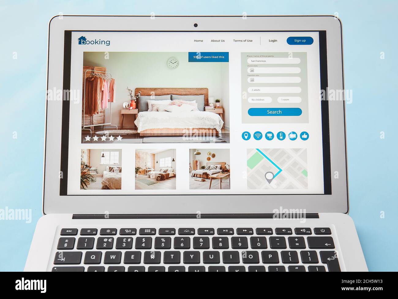 Open page of online booking service on screen of laptop on color ...