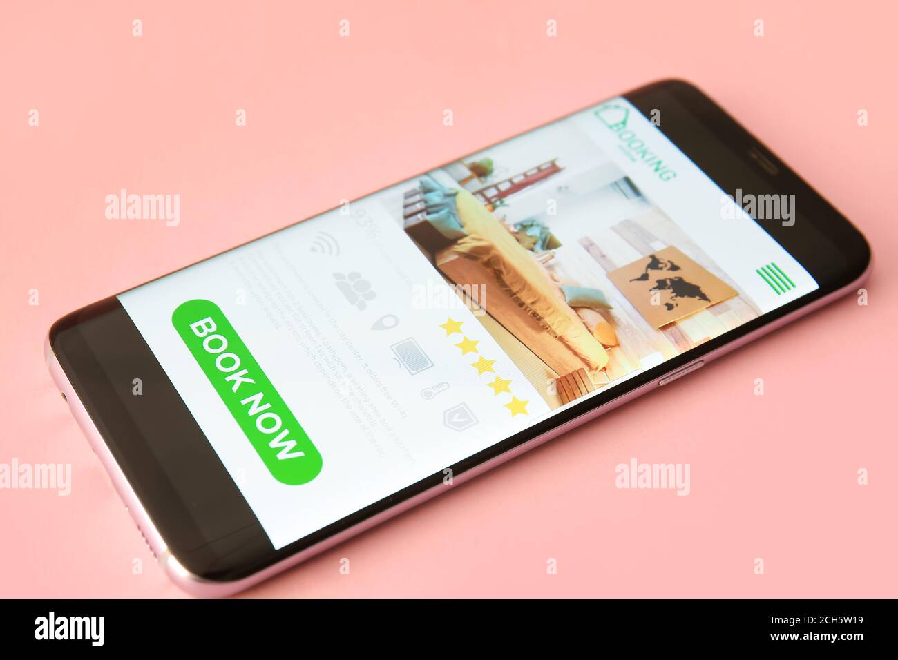 Open page of online booking service on screen of mobile phone on color background Stock Photo ...