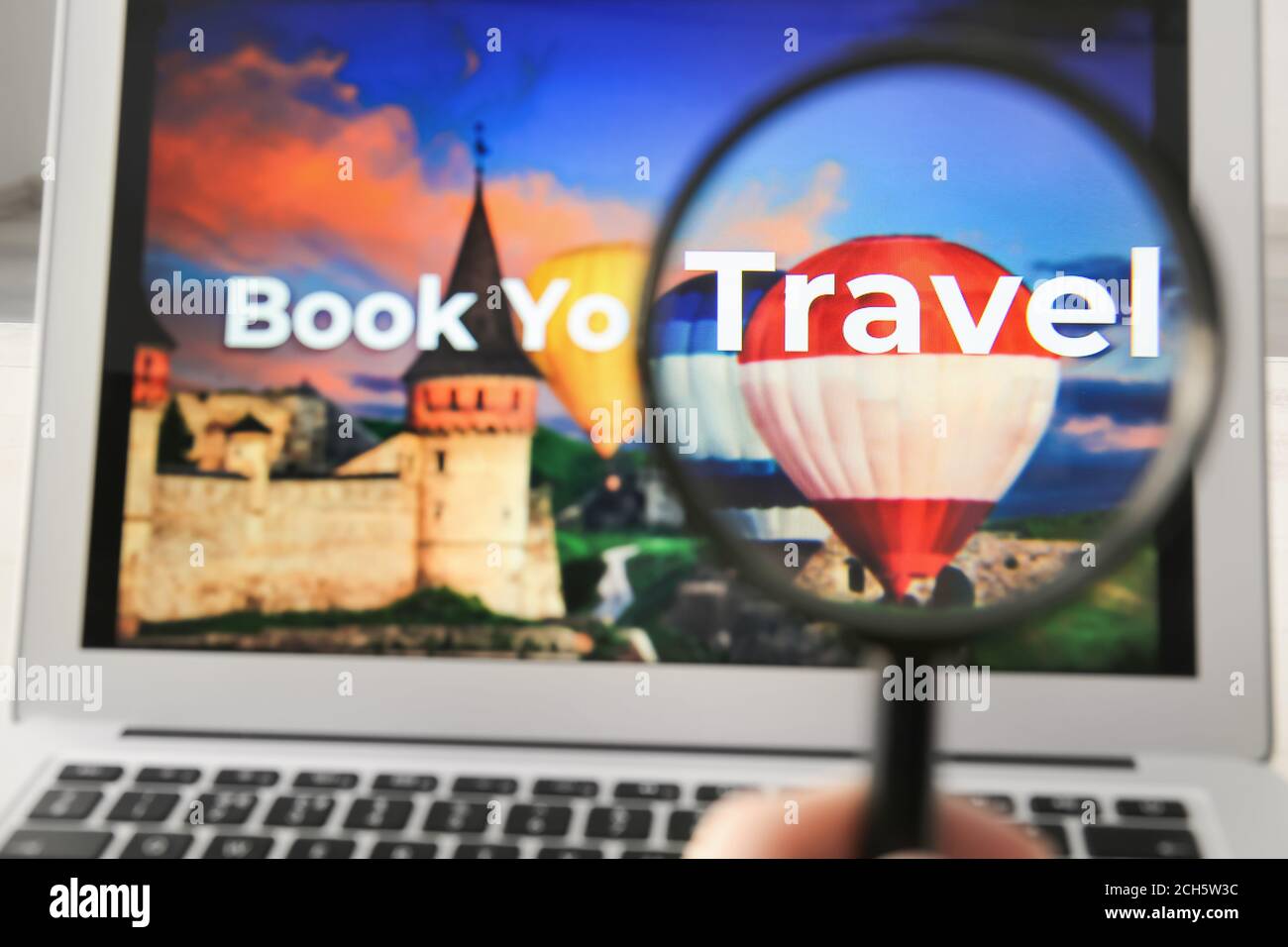 Open page of online booking service on screen of laptop, view through ...