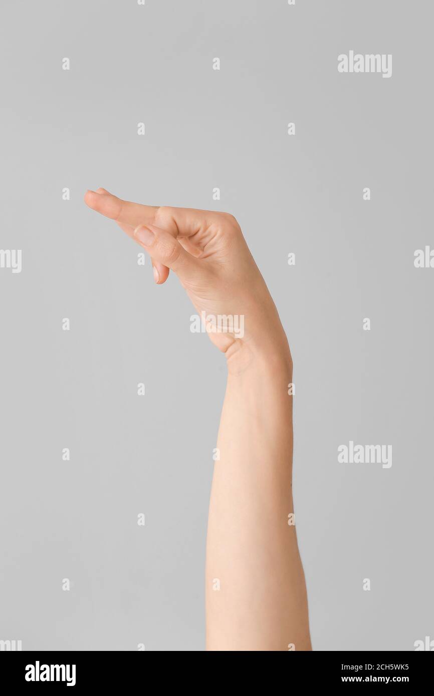 Hand showing letter F on grey background. Sign language alphabet Stock ...
