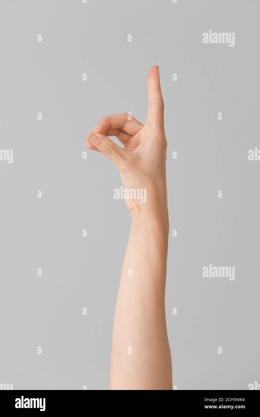 Hand showing letter D on grey background. Sign language alphabet Stock ...