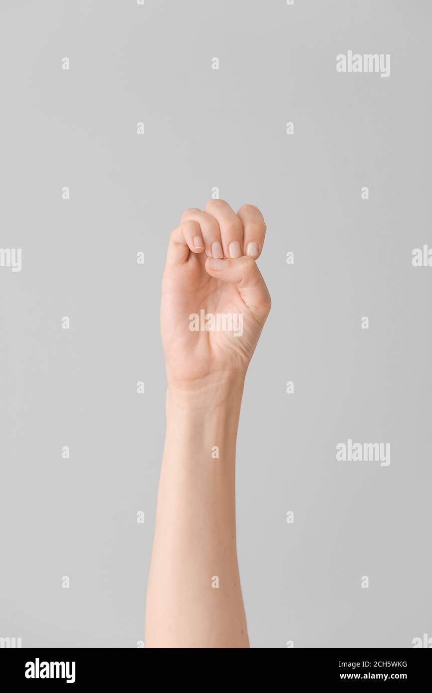 Hand showing letter E on grey background. Sign language alphabet Stock ...