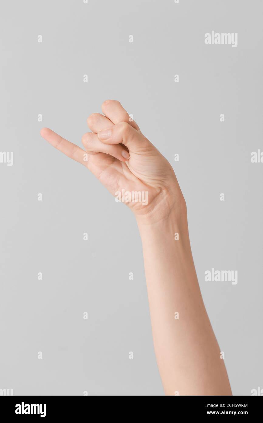 Hand showing letter J on grey background. Sign language alphabet Stock ...