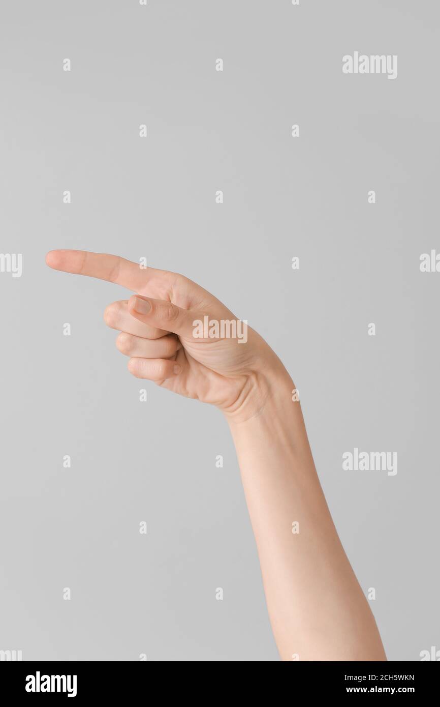Hand showing letter G on grey background. Sign language alphabet Stock ...