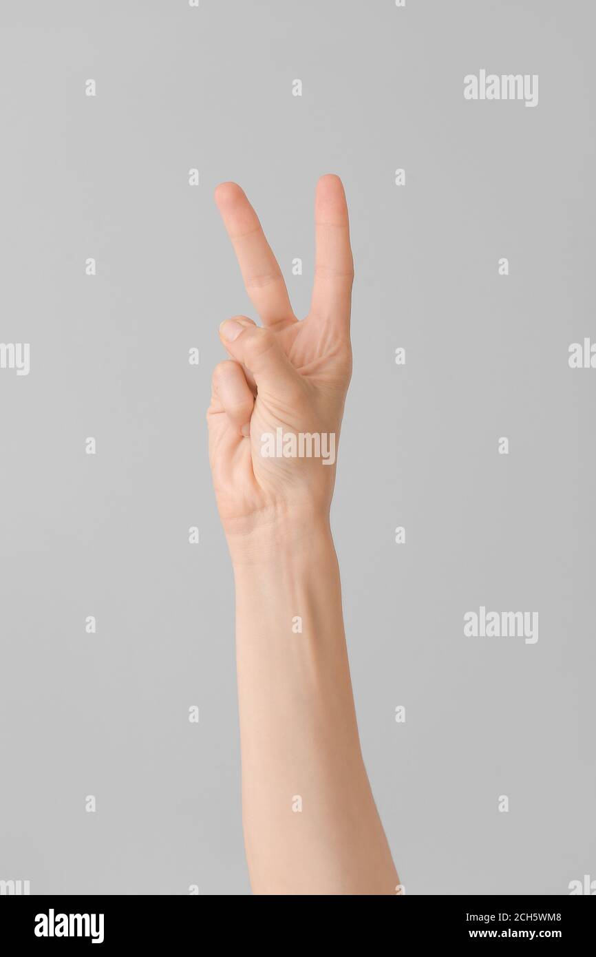 Hand showing letter K on grey background. Sign language alphabet Stock ...