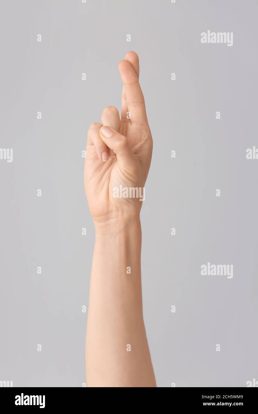 Hand showing letter R on grey background. Sign language alphabet Stock ...