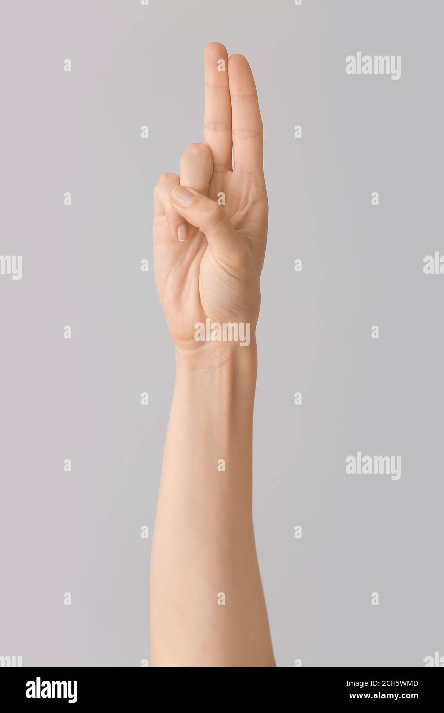 Hand showing letter U on grey background. Sign language alphabet Stock ...
