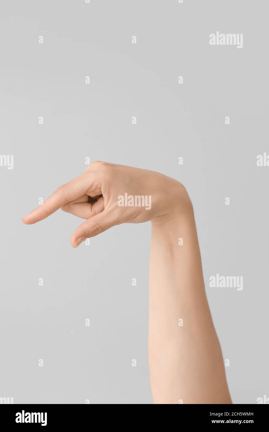 Hand showing letter Q on grey background. Sign language alphabet Stock ...