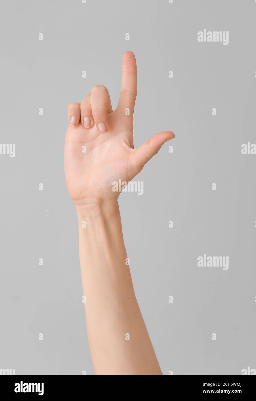 Hand showing letter L on grey background. Sign language alphabet Stock ...