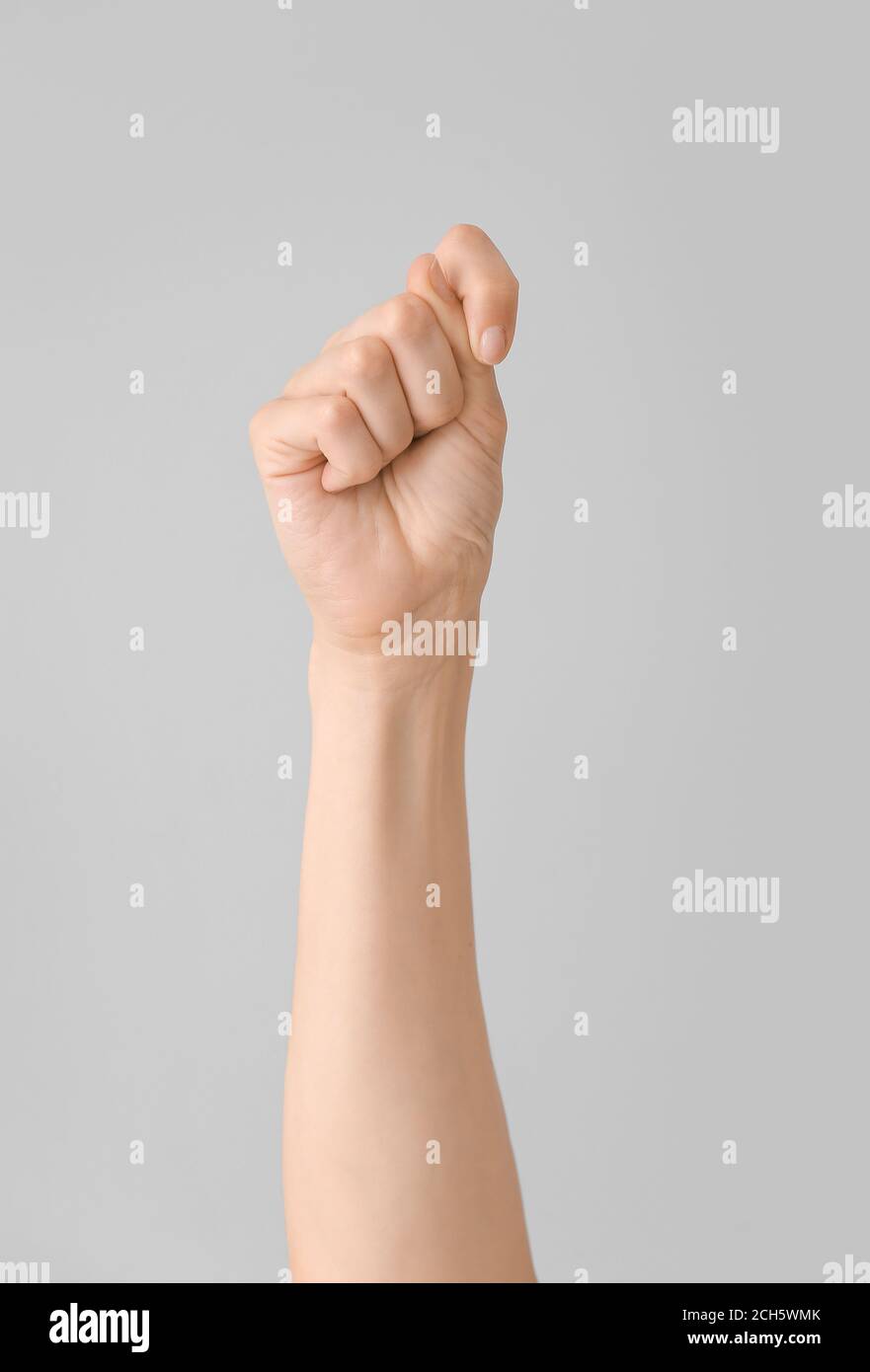 Hand showing letter T on grey background. Sign language alphabet Stock ...