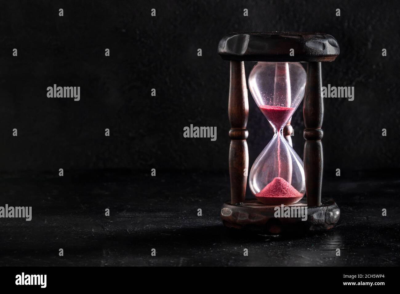 Time concept. An hourglass on a black background with copy space Stock ...