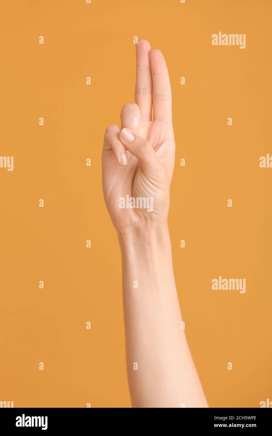 Hand showing letter U on color background. Sign language alphabet Stock ...