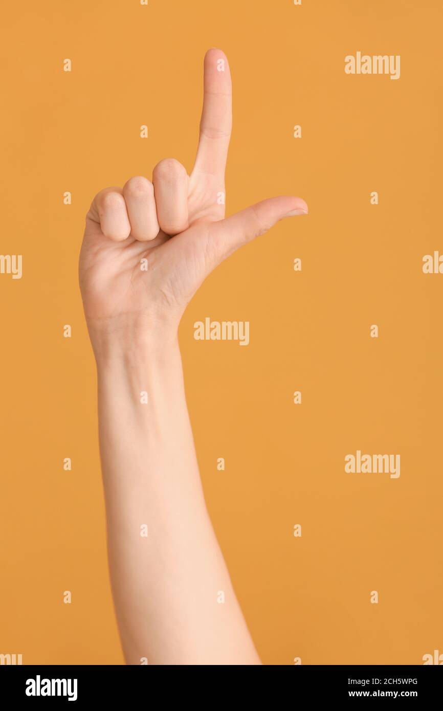 Hand showing letter L on color background. Sign language alphabet Stock ...