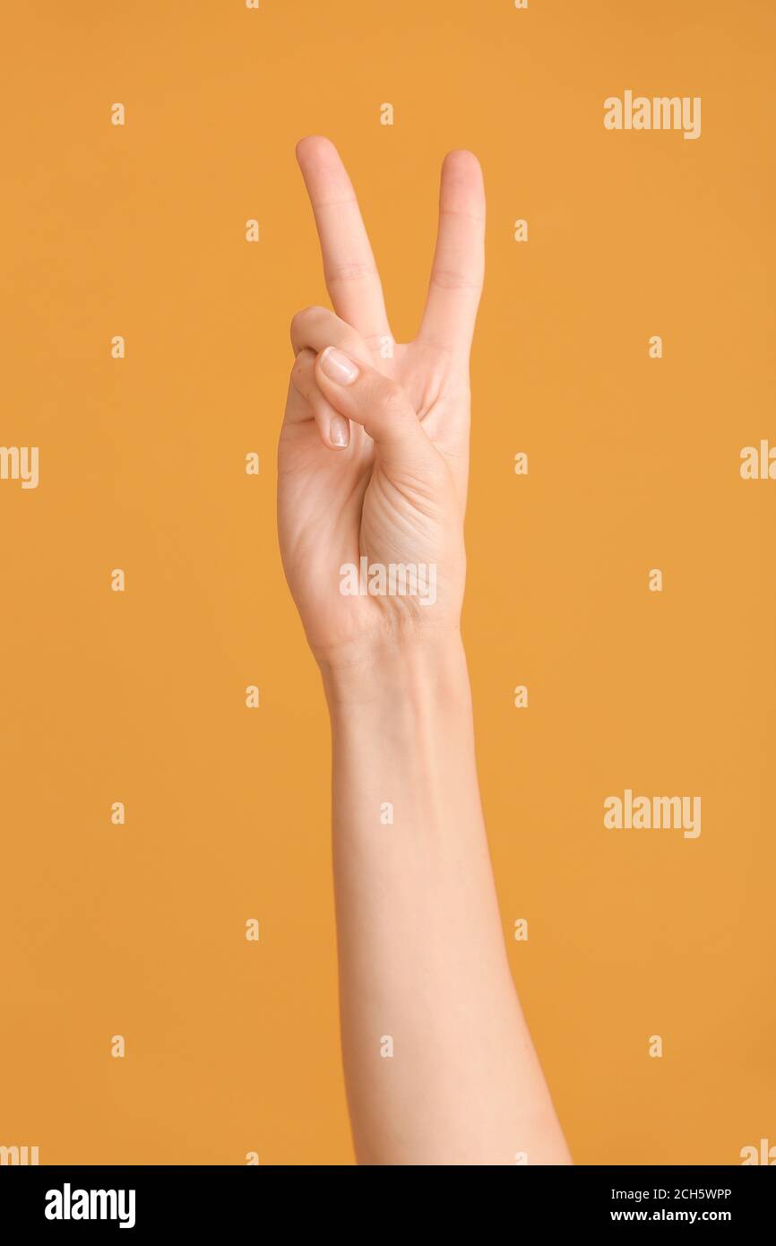 Hand showing letter V on color background. Sign language alphabet Stock ...