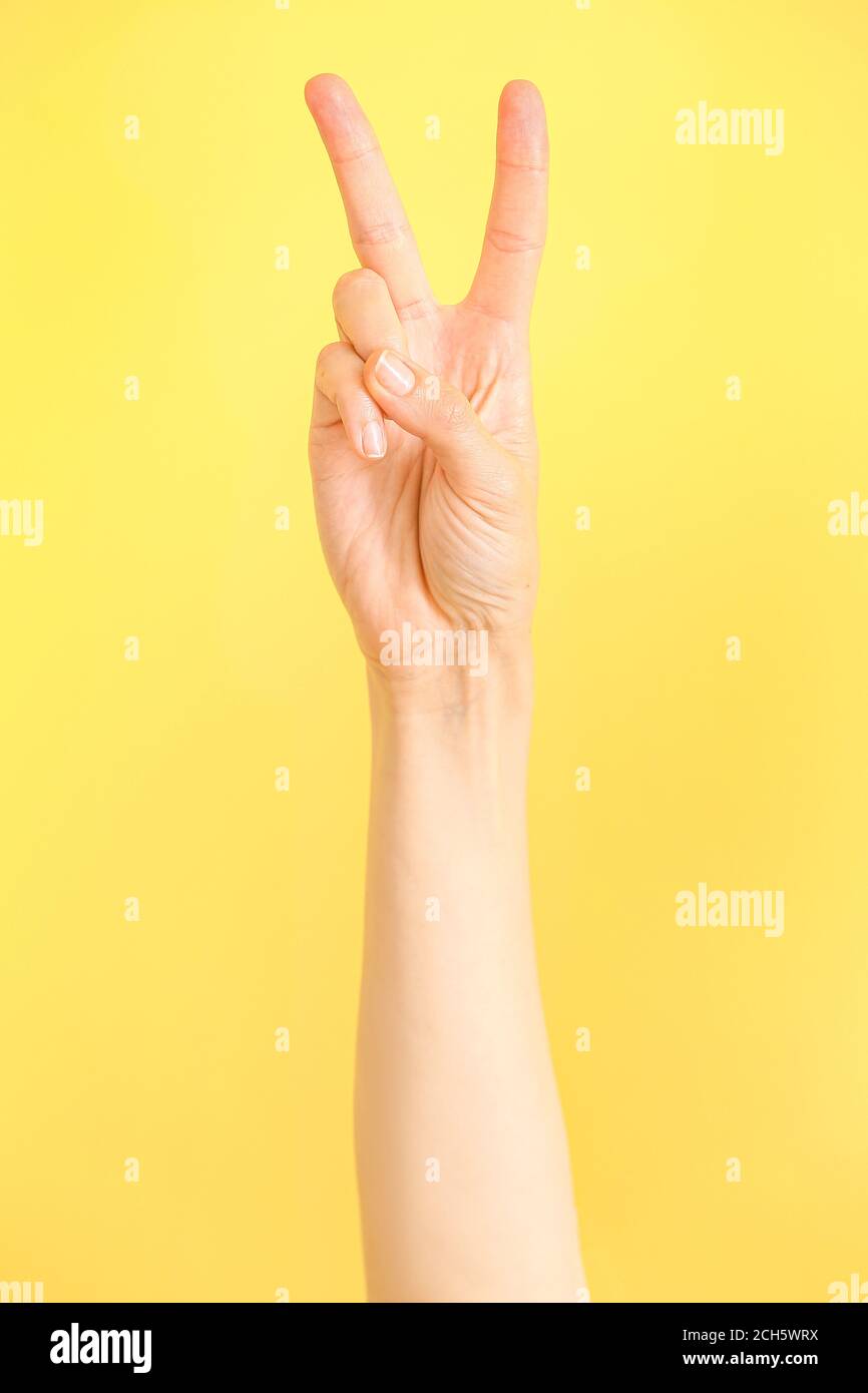 Hand showing letter V on color background. Sign language alphabet Stock ...