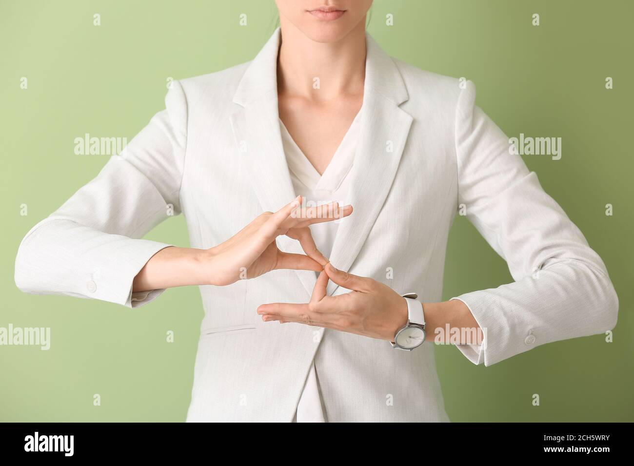 Young deaf mute woman using sign language on color background Stock ...