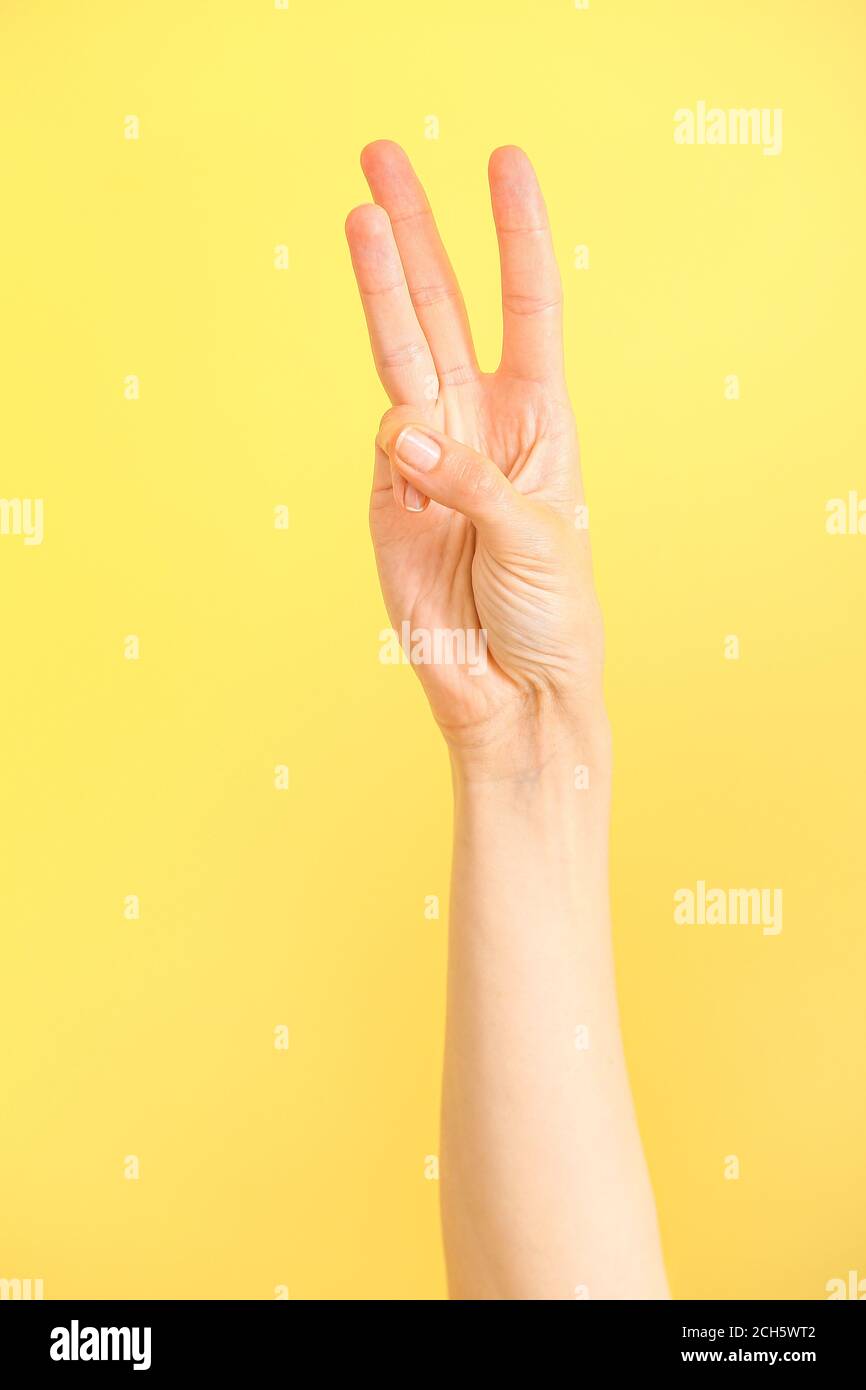 Hand showing letter W on color background. Sign language alphabet Stock ...