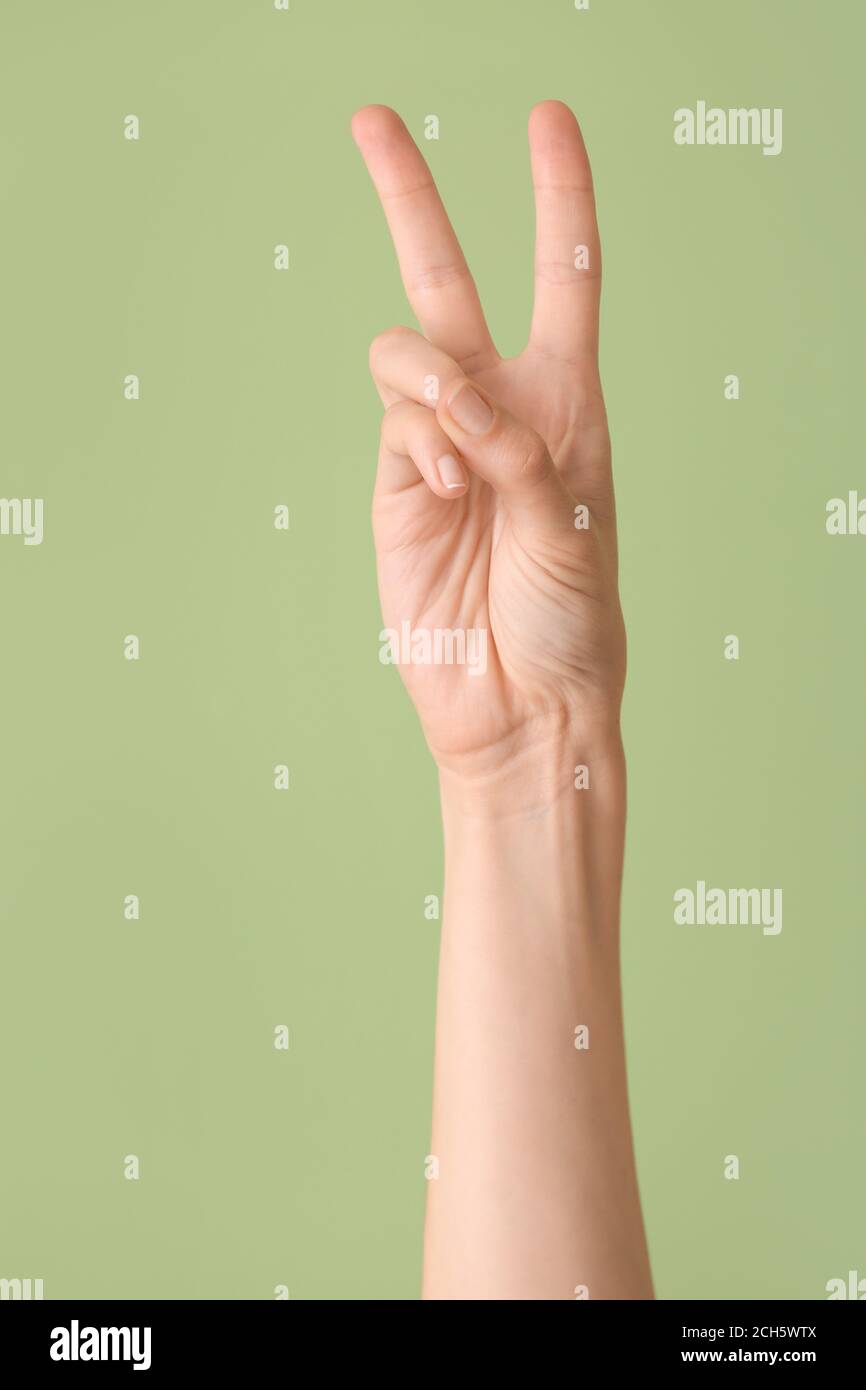 Hand showing letter V on color background. Sign language alphabet Stock ...