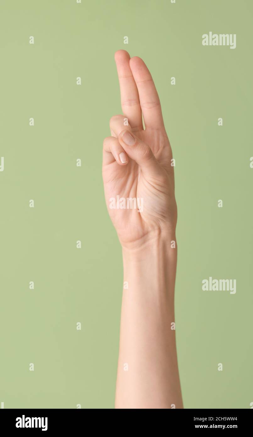 Hand showing letter U on color background. Sign language alphabet Stock ...
