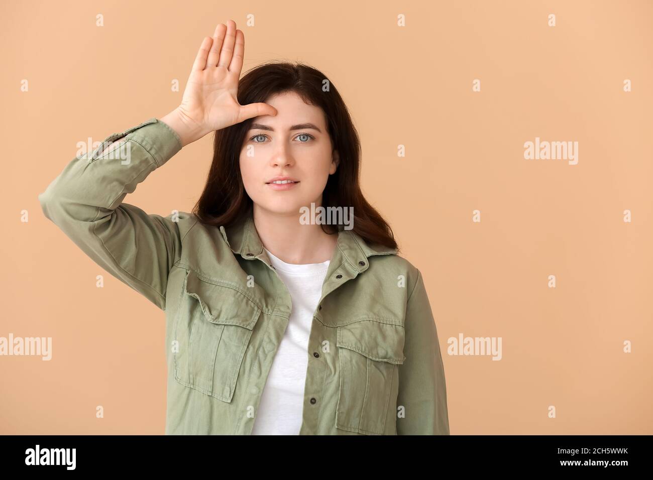 Young deaf mute woman using sign language on color background Stock ...