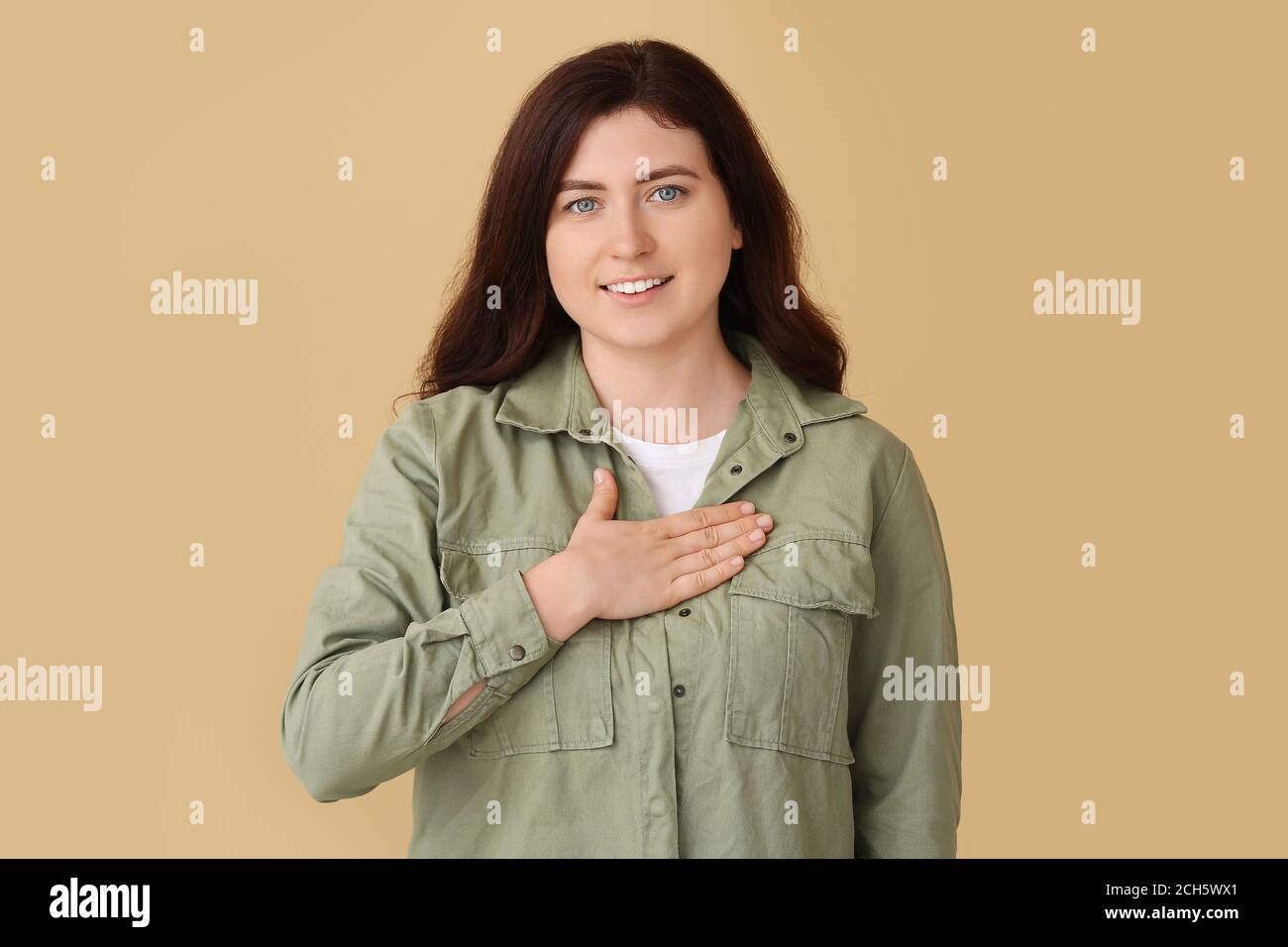 Young deaf mute woman using sign language on color background Stock ...