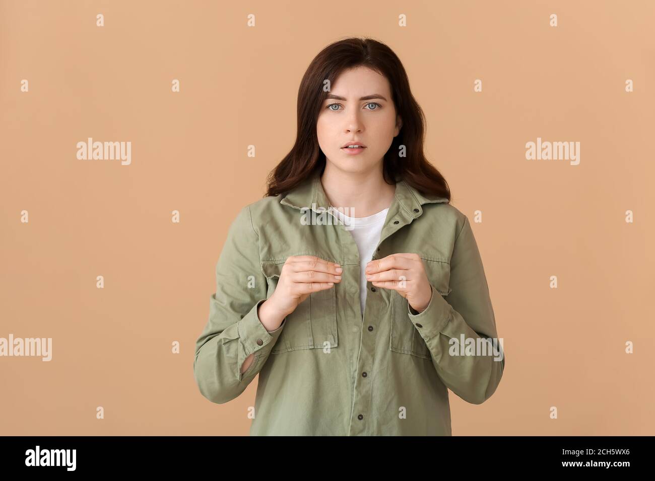 Young deaf mute woman using sign language on color background Stock ...