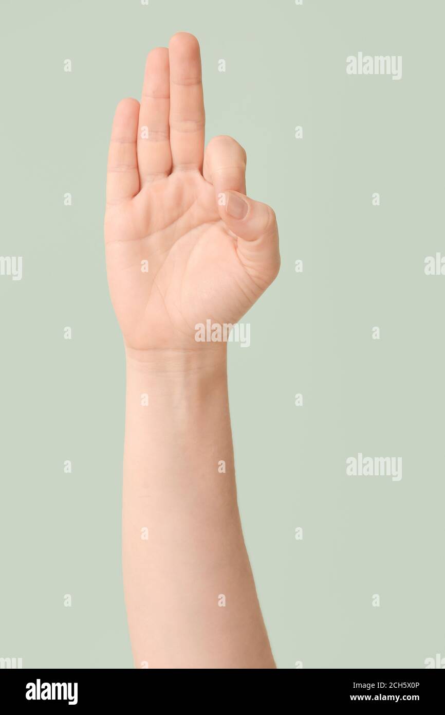 Hand showing letter F on color background. Sign language alphabet Stock ...