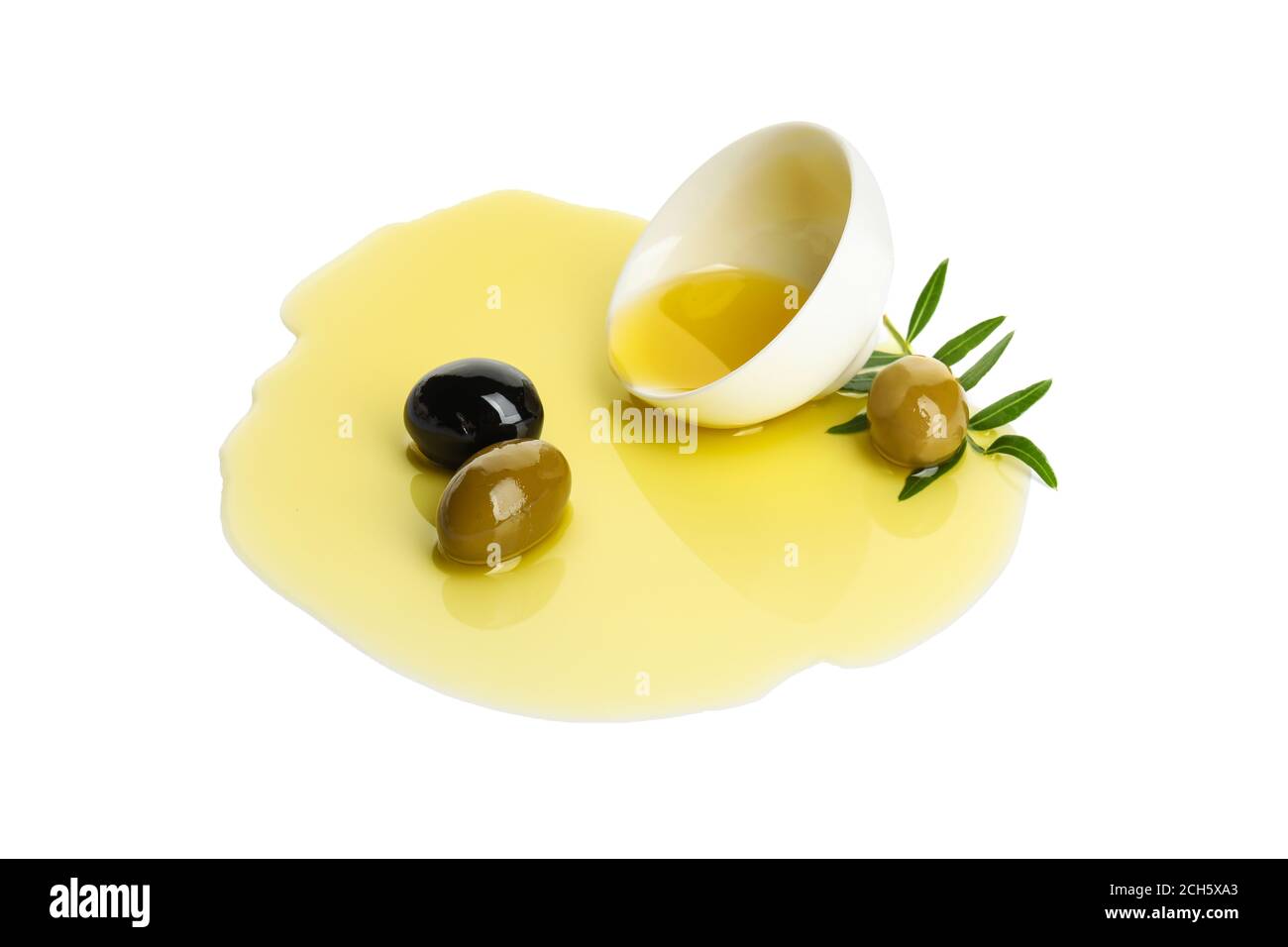 Bowl and spilled olive oil on white background Stock Photo - Alamy