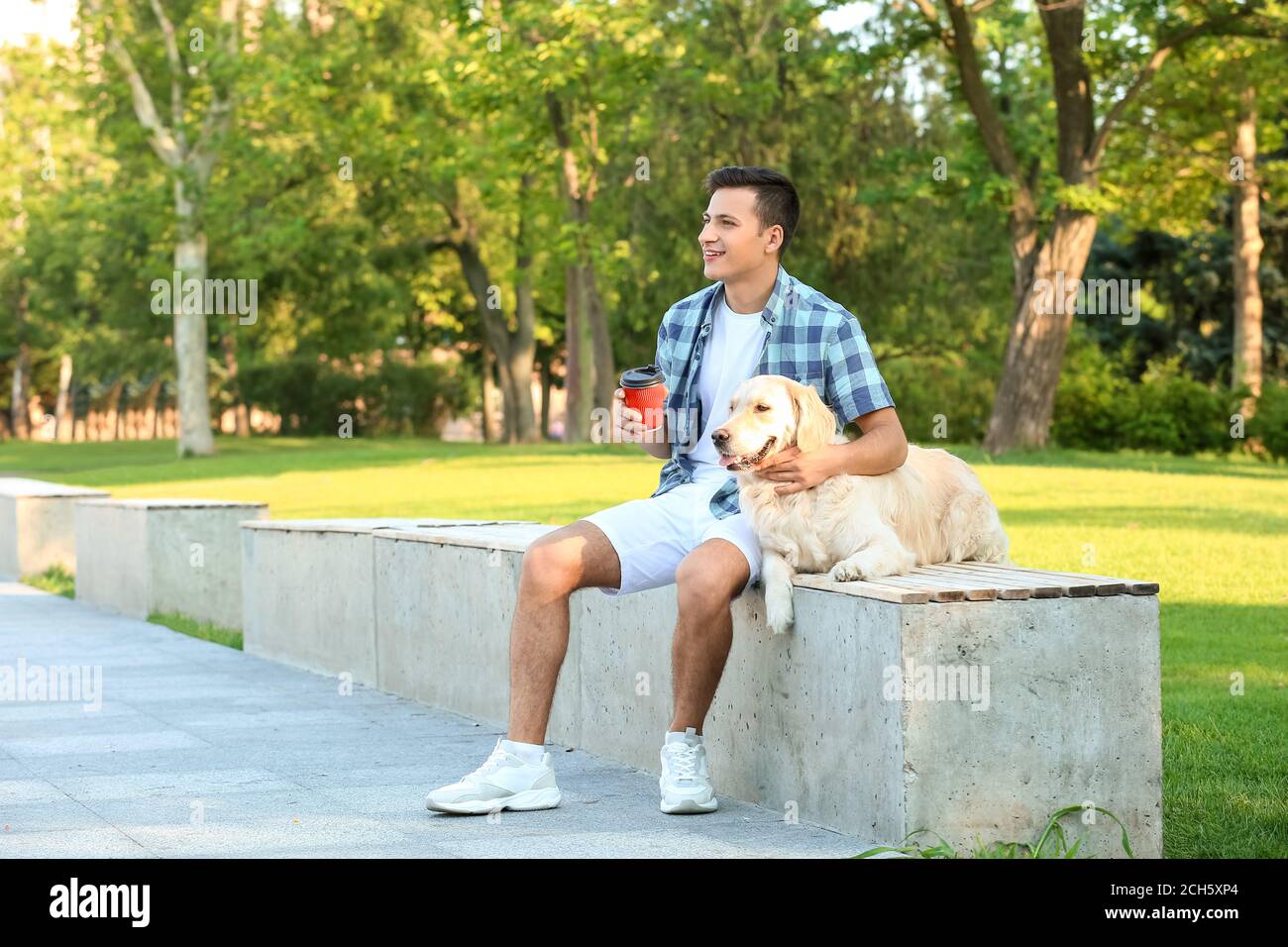 Young man with cute dog walking outdoors Stock Photo - Alamy