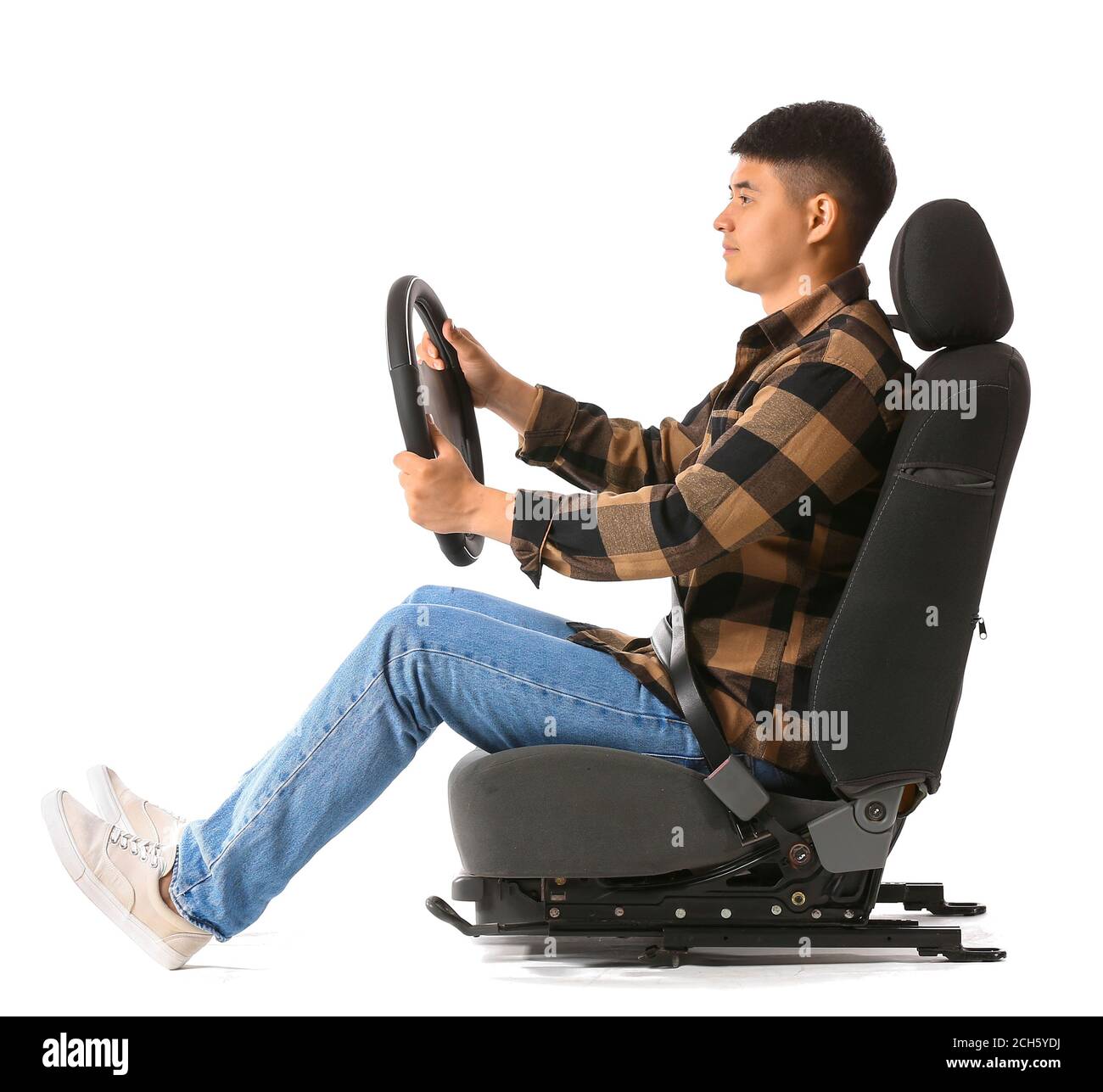 Asian man with steering wheel sitting on car seat against white ...