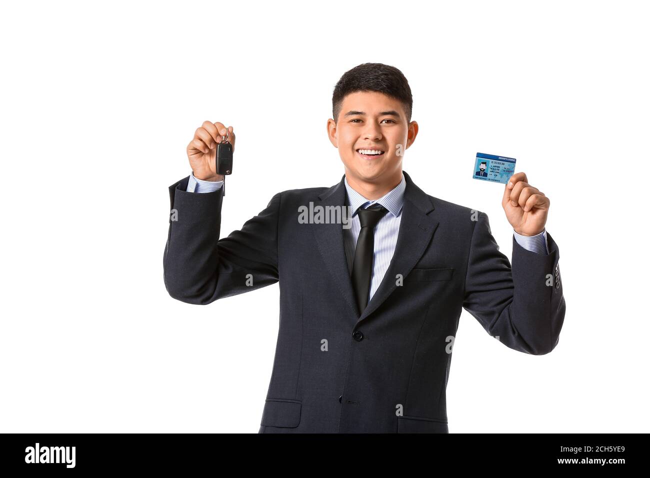 Happy Asian businessman with car key and driving license on white ...