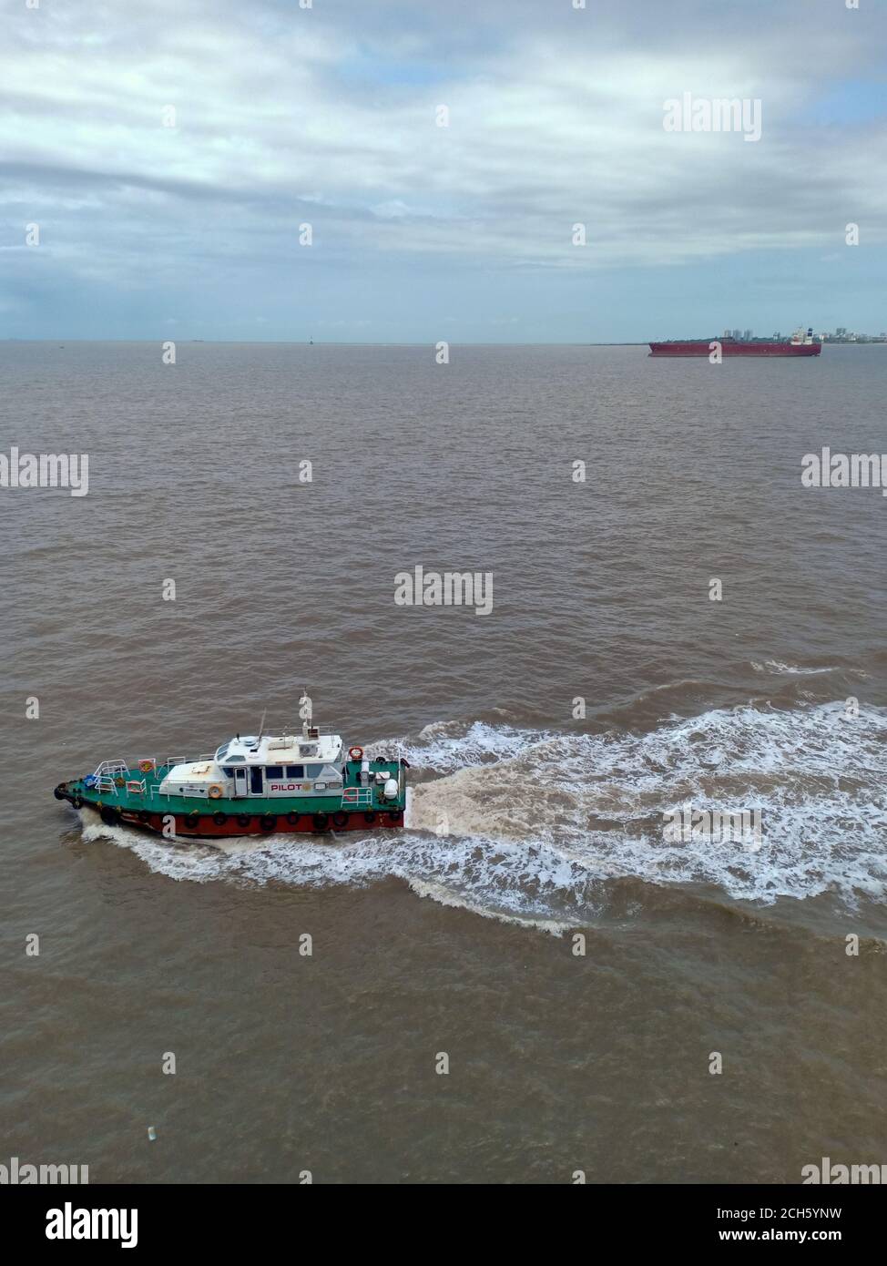 a pilot boat approaching cruise ship Stock Photo - Alamy
