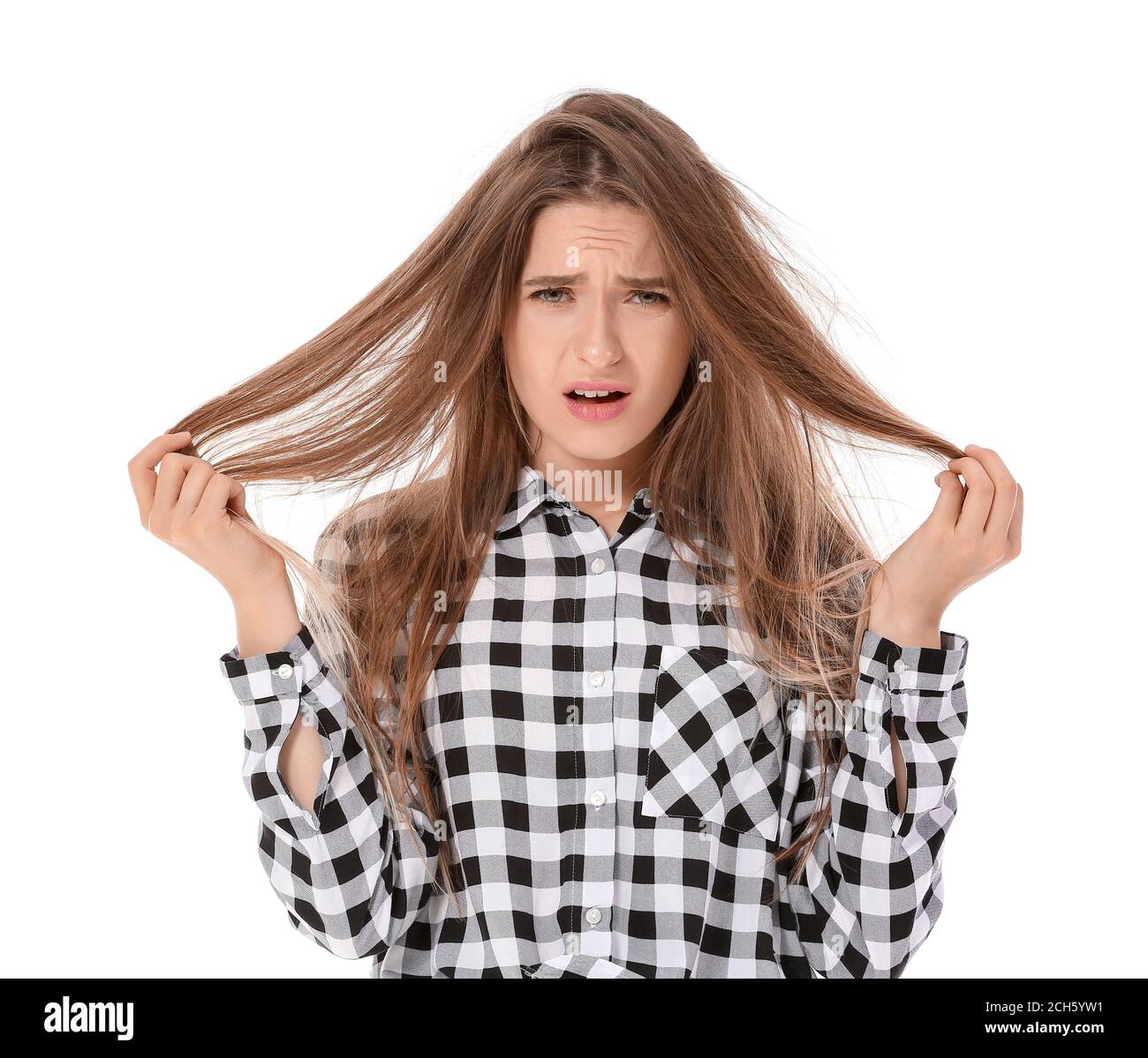 Stressed woman with hair problem on white background Stock Photo - Alamy
