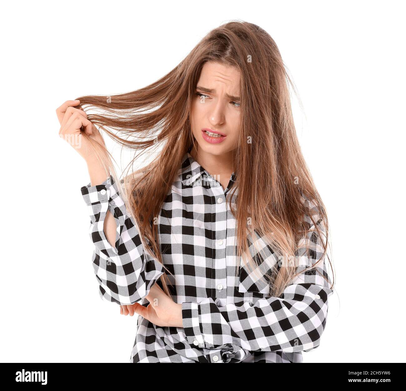 Stressed woman with hair problem on white background Stock Photo - Alamy