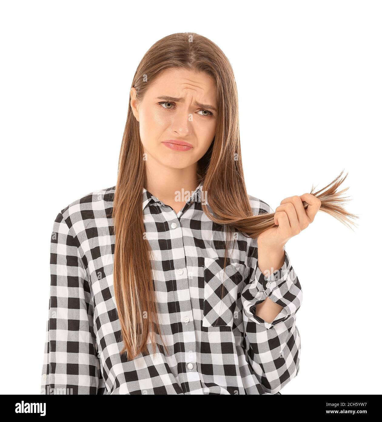 Stressed woman with hair problem on white background Stock Photo - Alamy