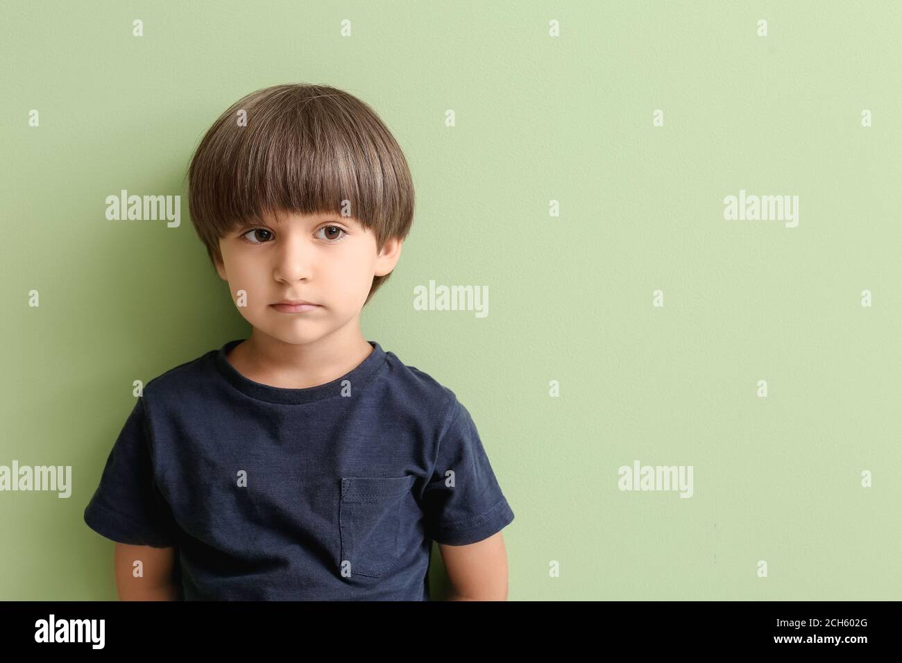 Little boy with autistic disorder on color background Stock Photo - Alamy