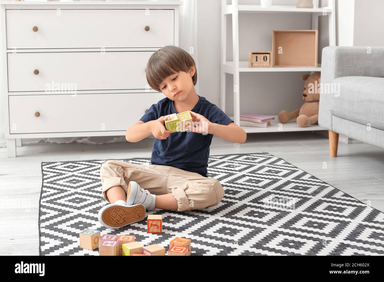 Little boy with autistic disorder playing with cubes at home Stock ...