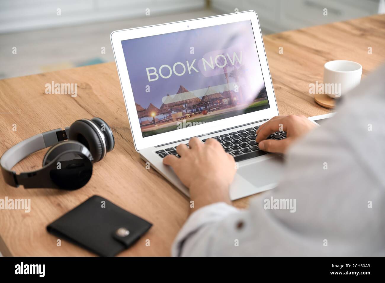 Man with laptop booking room in hotel online at home Stock Photo - Alamy