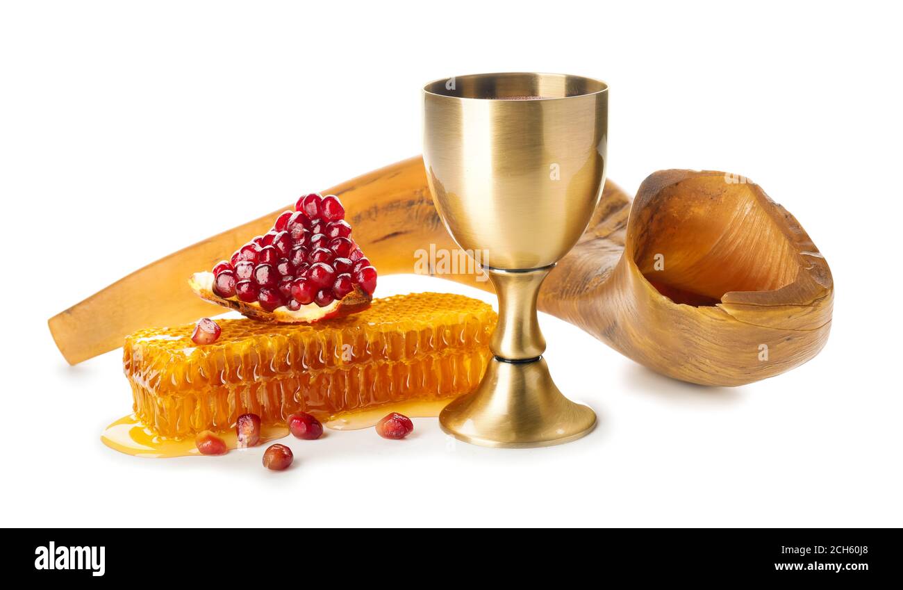 Shofar, sacramental goblet with wine, honey and pomegranate on white ...