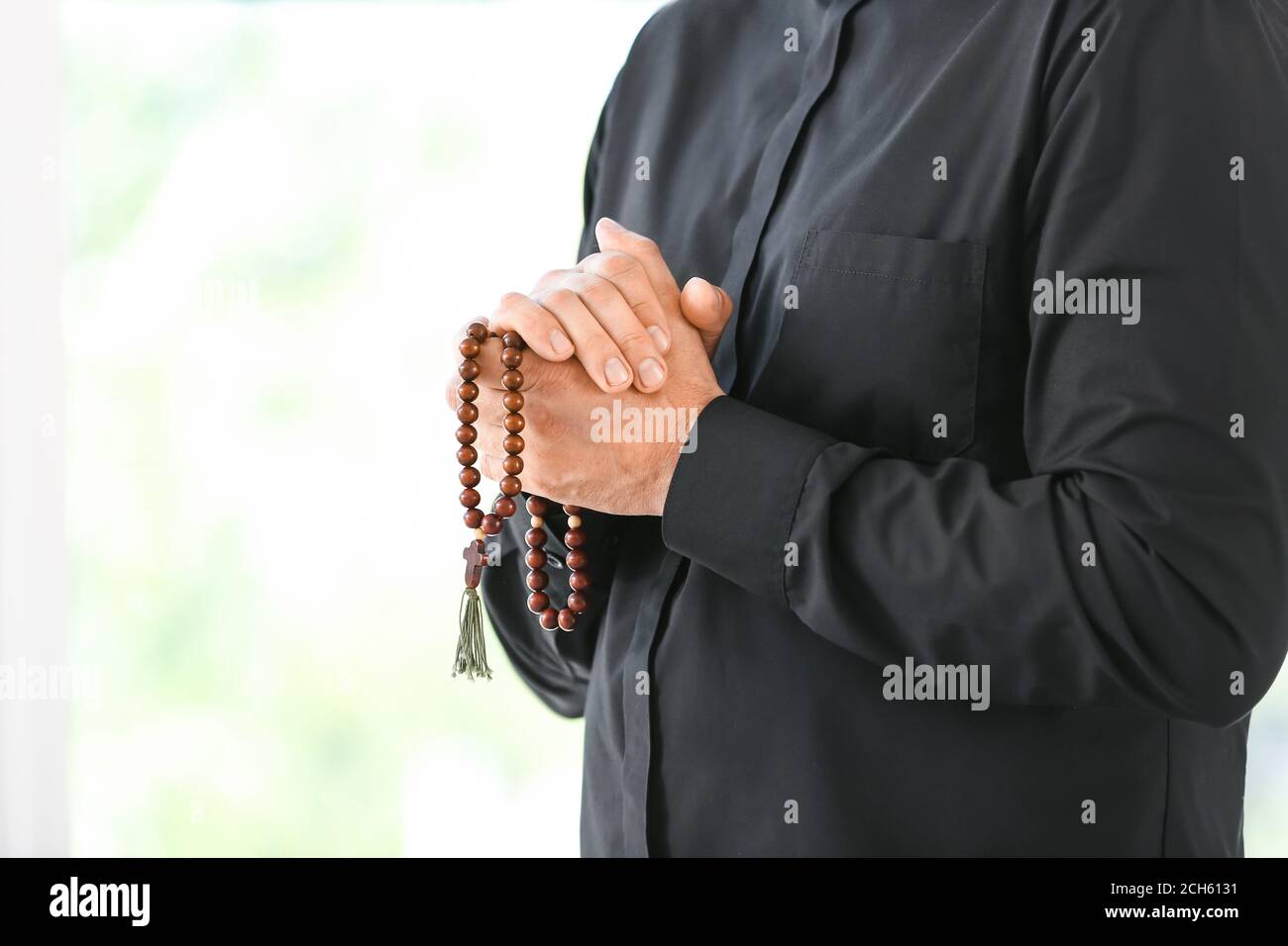 Male praying priest with rosary beads, closeup Stock Photo - Alamy