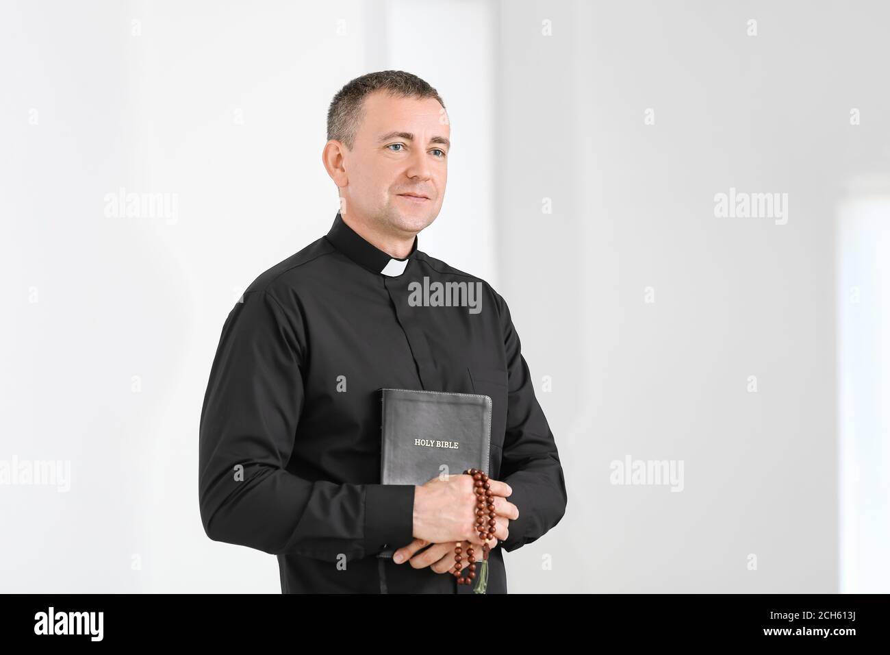 Portrait of male priest at home Stock Photo - Alamy