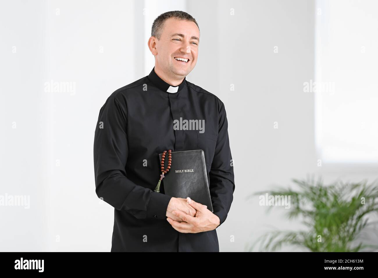Portrait of male priest at home Stock Photo - Alamy