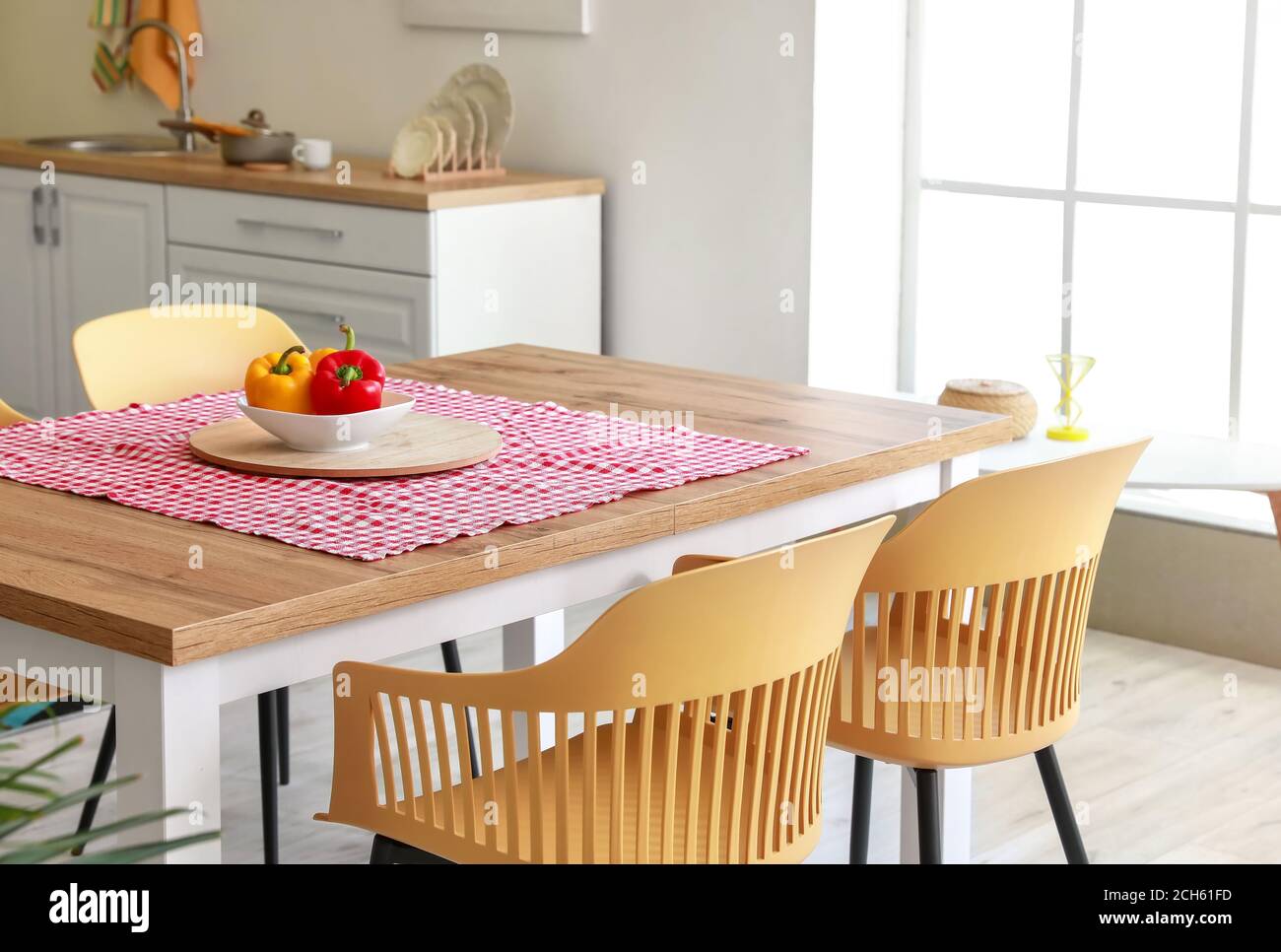 Dining table in interior of modern kitchen Stock Photo - Alamy
