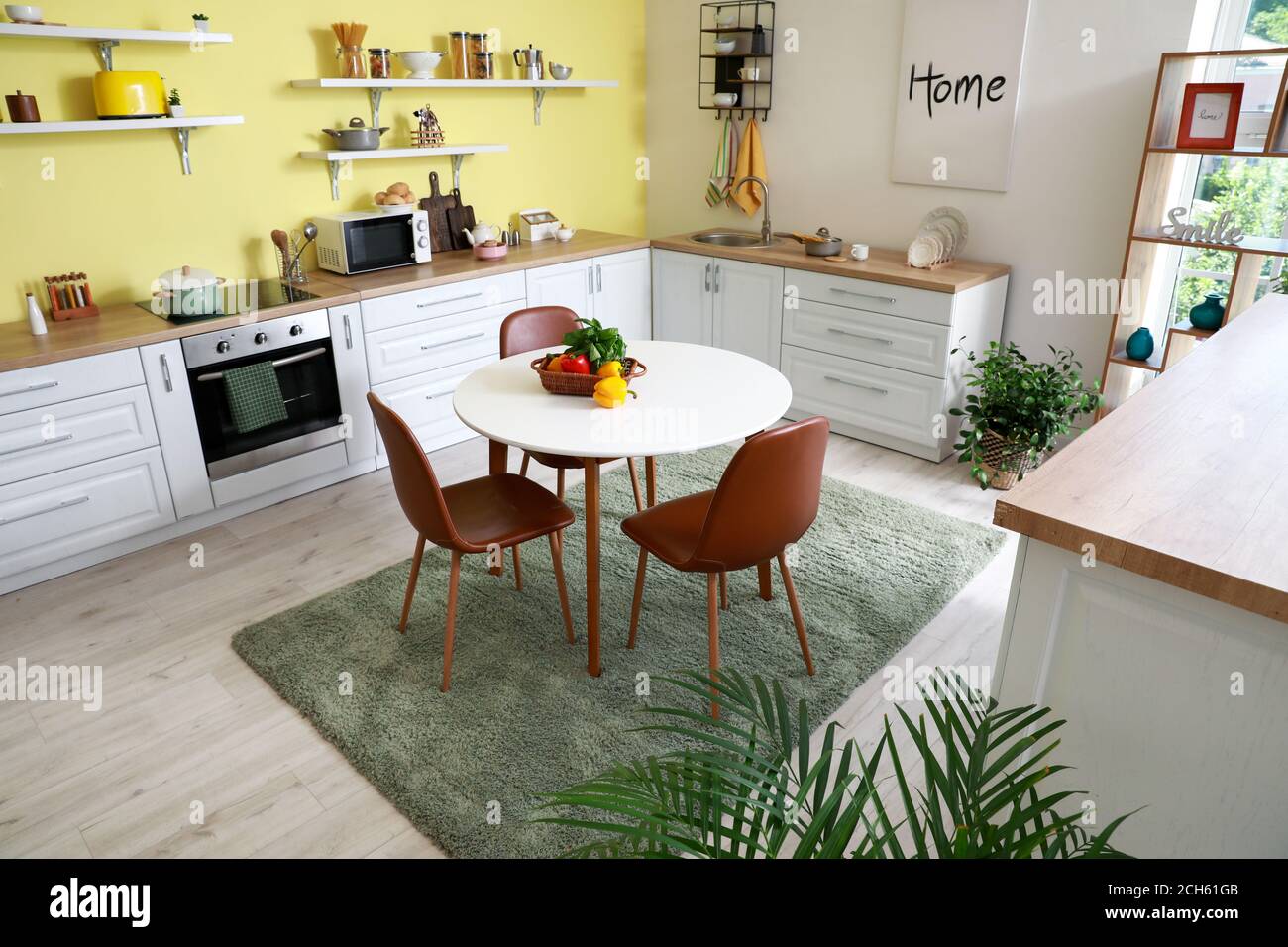 Dining table in interior of modern kitchen Stock Photo - Alamy