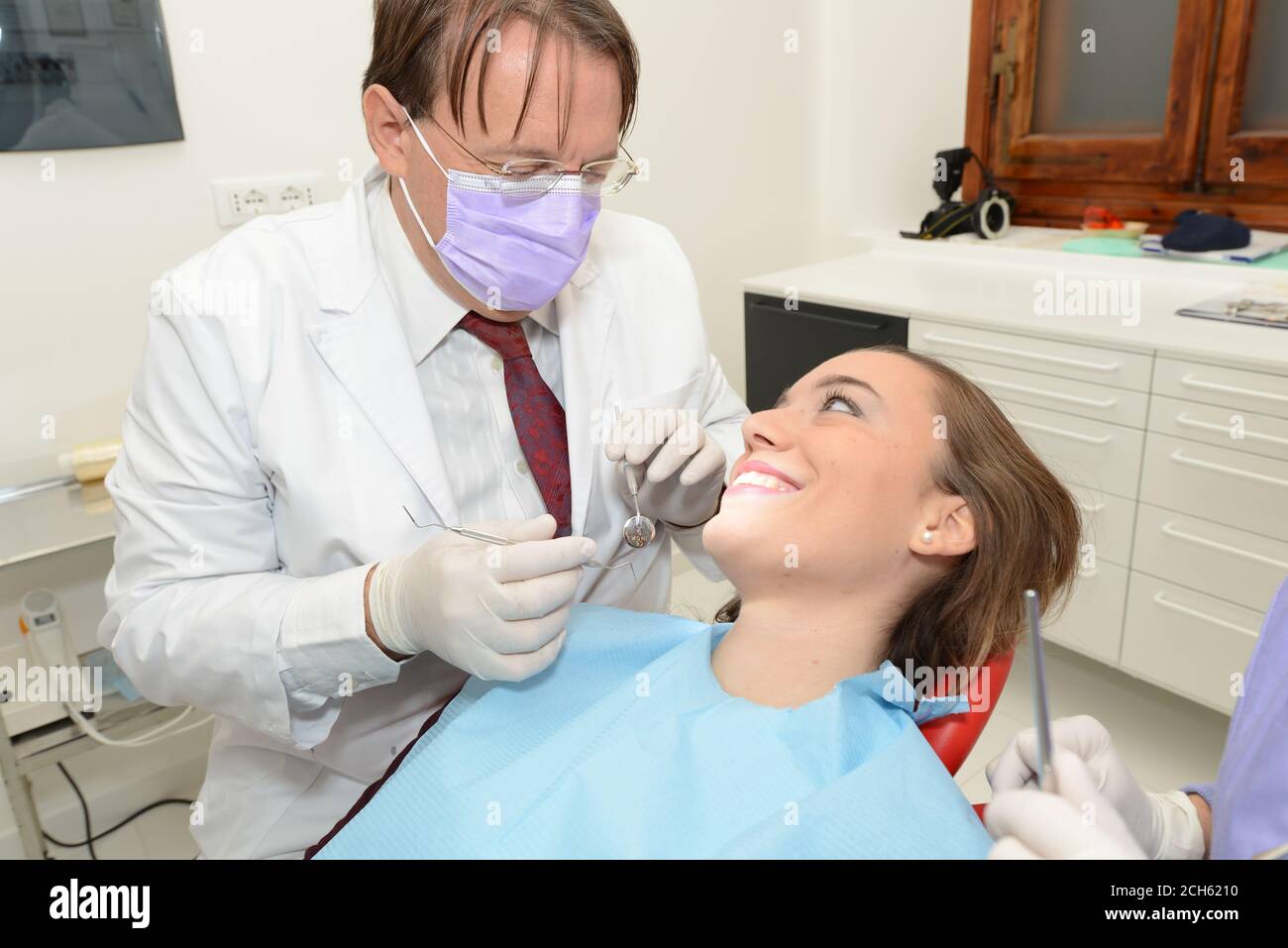 Attractive young girl waiting with trust her doc dad working on a ...
