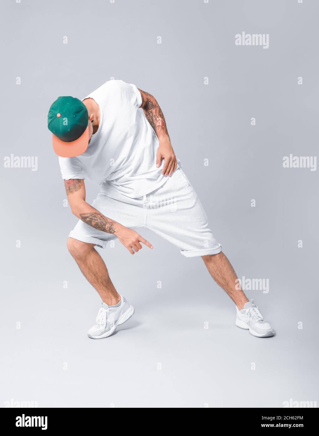 Male hip-hop dancer on grey background Stock Photo - Alamy