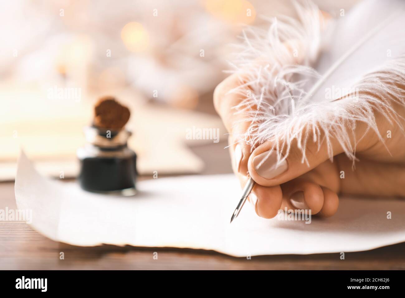 Woman writing letter with feather pen, closeup Stock Photo - Alamy