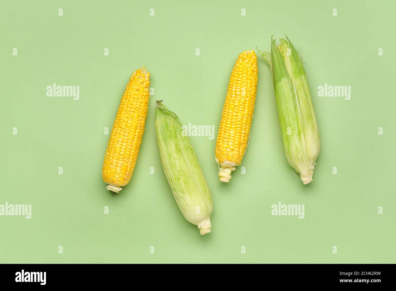 Fresh corn cobs on color background Stock Photo - Alamy