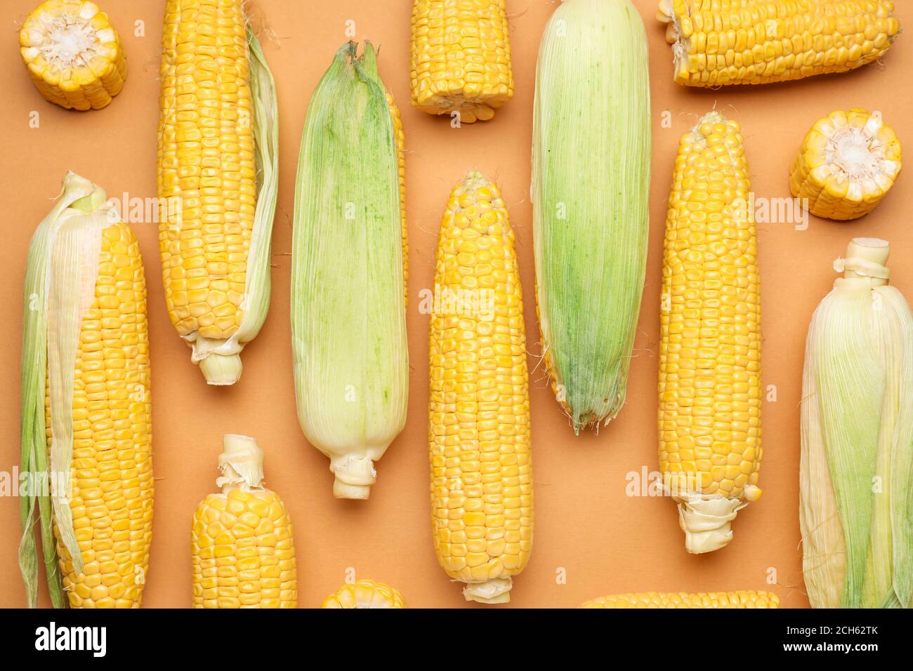 Fresh corn cobs on color background Stock Photo - Alamy